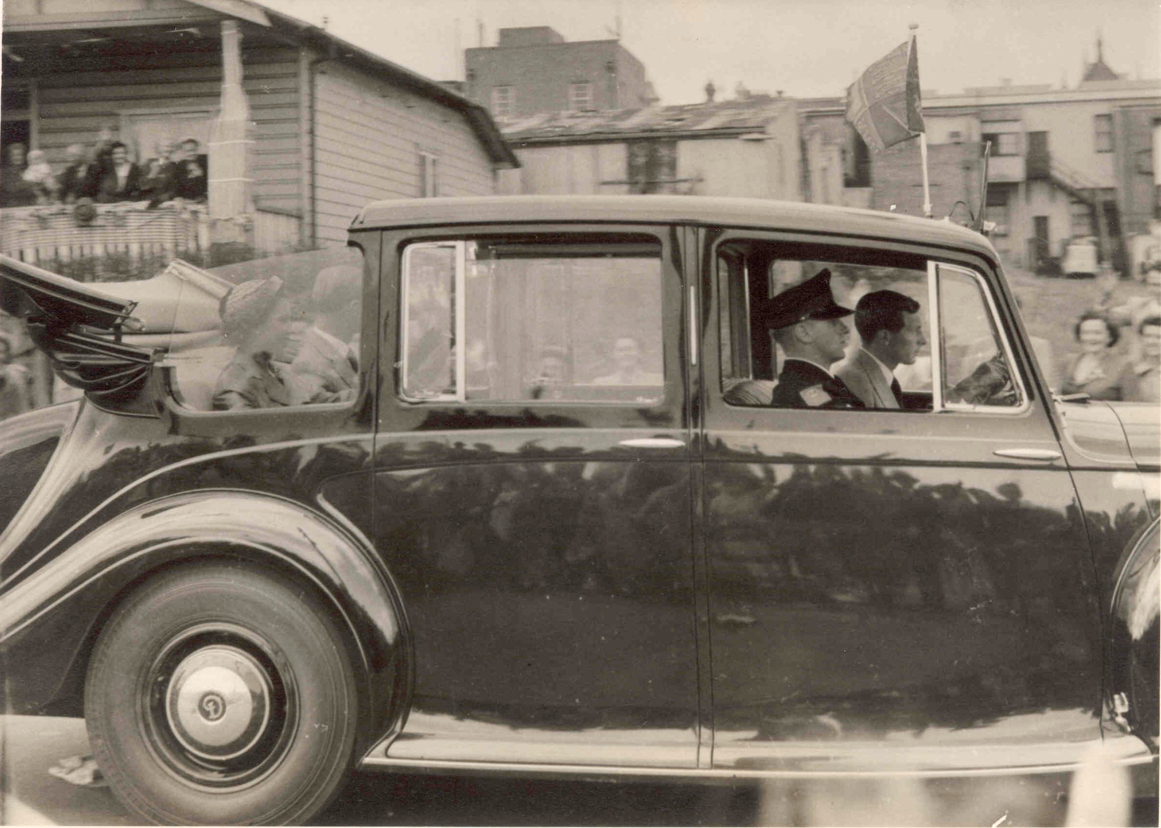 Queen Elizabeth and Prince Philip travelling through streets ...